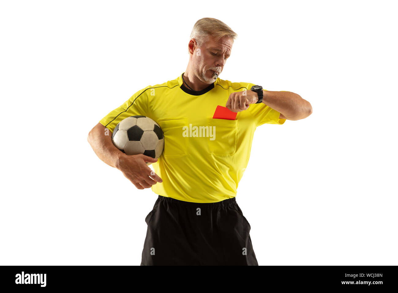 Referee holding ball and showing a red card to a football or soccer ...
