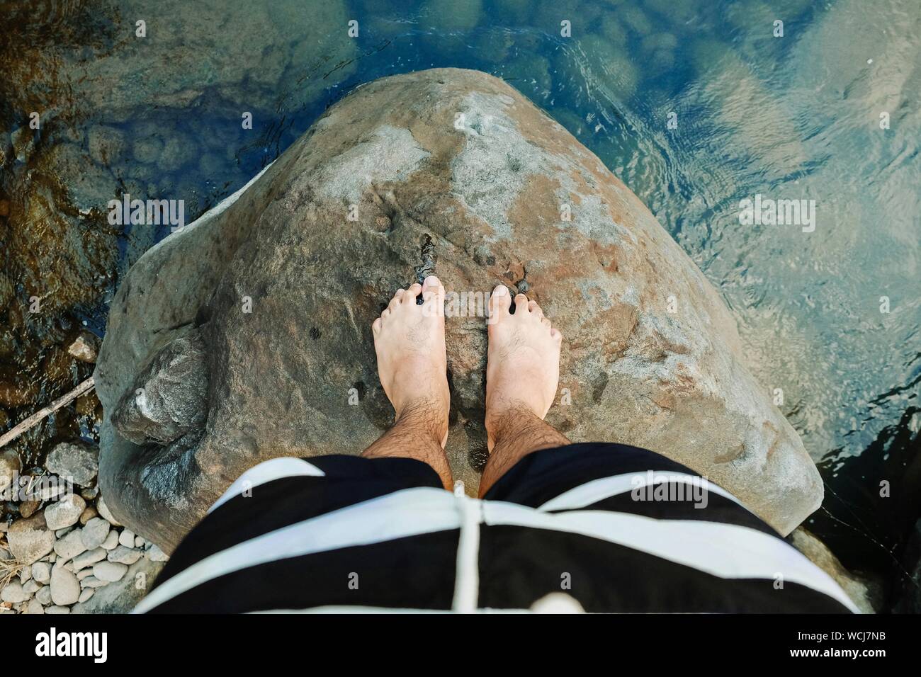 Man standing barefoot on rock hi-res stock photography and images - Alamy