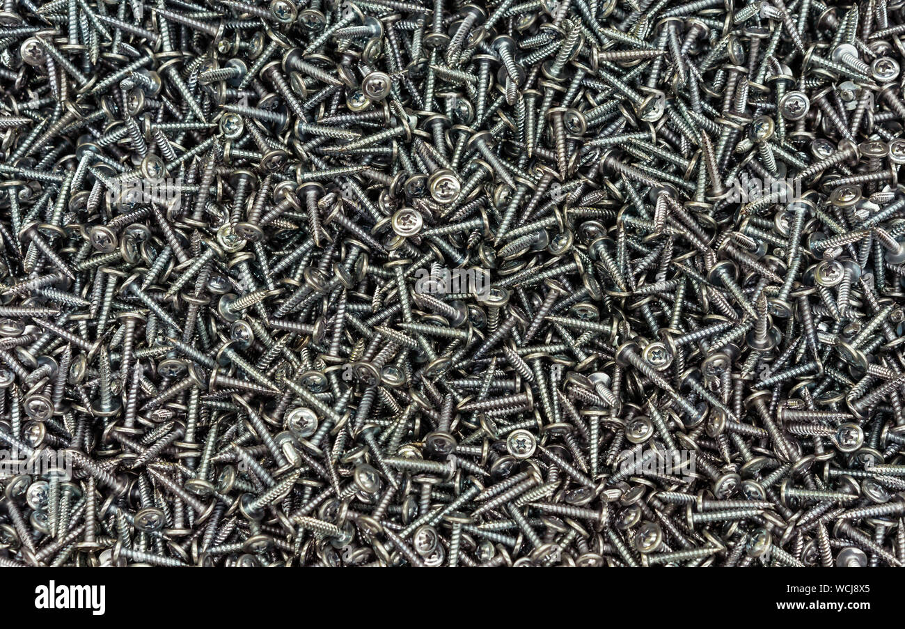 Chrome screws on the counter of a hardware store. Background of the ...