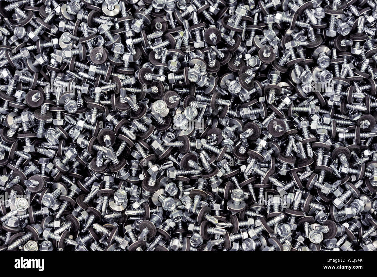 Chrome screws on the counter of a hardware store. Background of the ...
