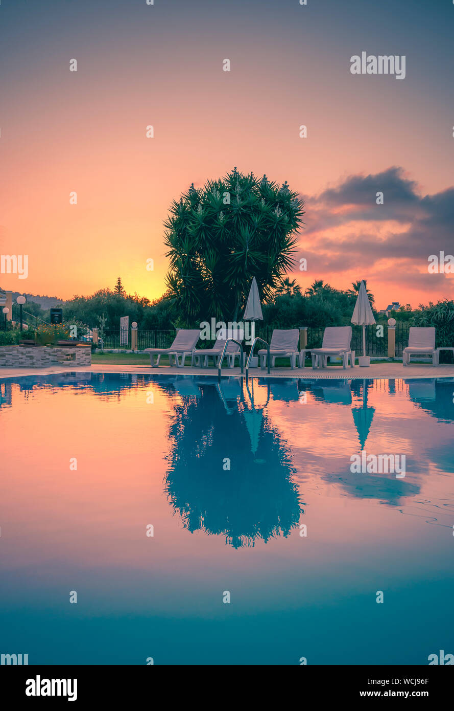 Poolside during beautiful sunset on Corfu Greece Stock Photo - Alamy