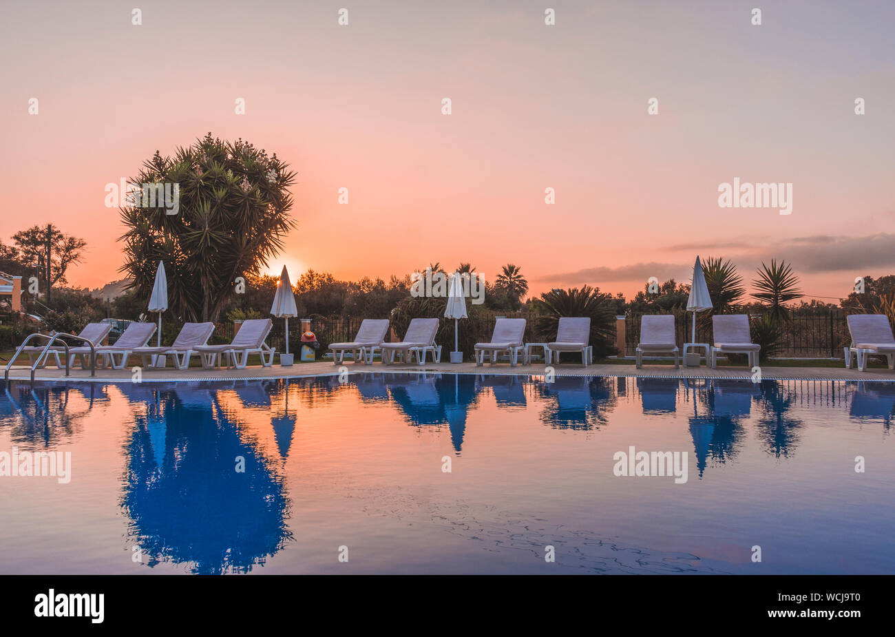 Poolside during beautiful sunset on Corfu Greece Stock Photo - Alamy
