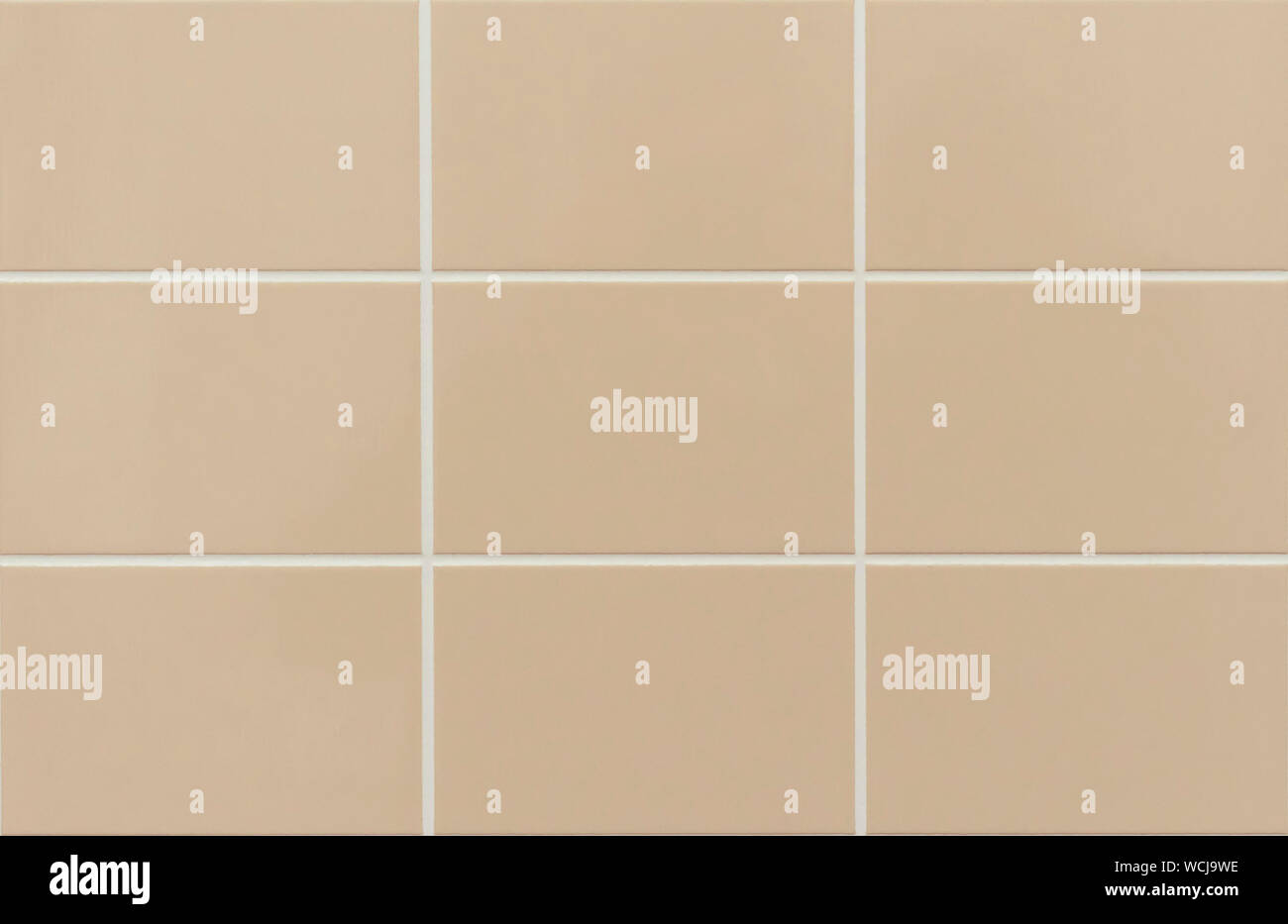 Beige ceramic tile on the wall in the bathroom. Background from beige ...