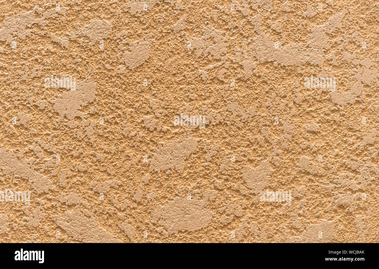 Texture of beige decorative plaster on the wall in the interior of the ...