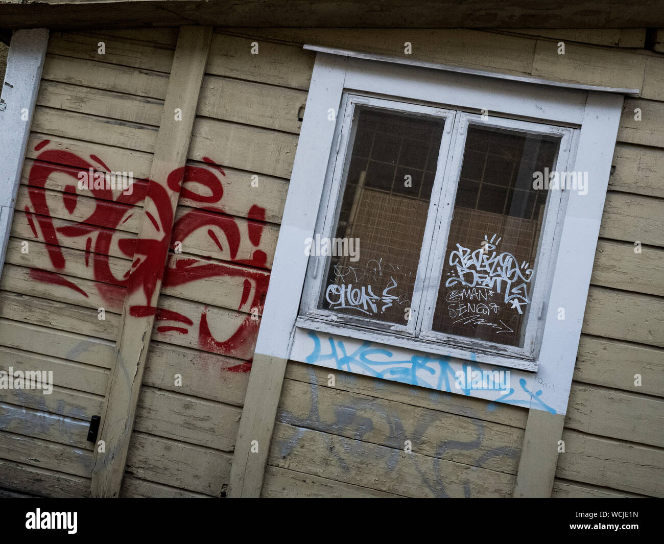 Rugged window with graffiti Stock Photo - Alamy