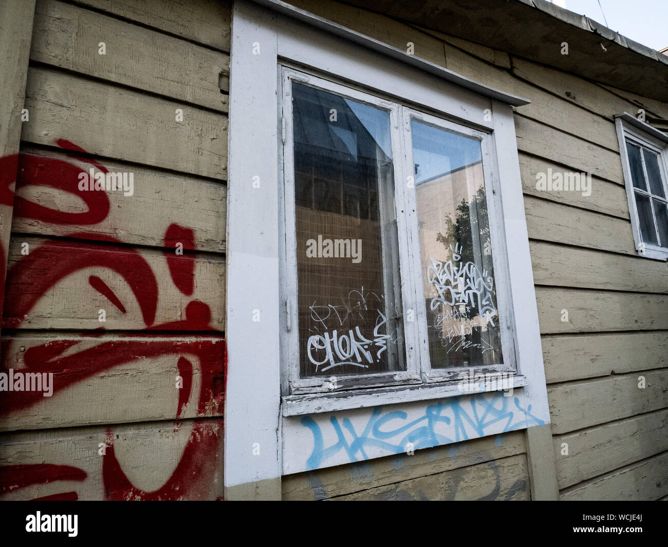 Rugged window with graffiti Stock Photo - Alamy