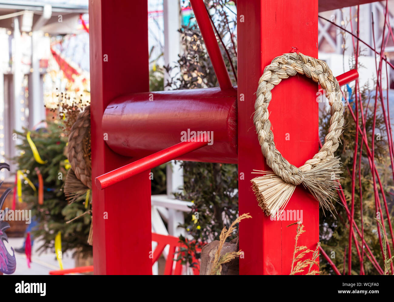 Straw decoration on an old red well Stock Photo - Alamy