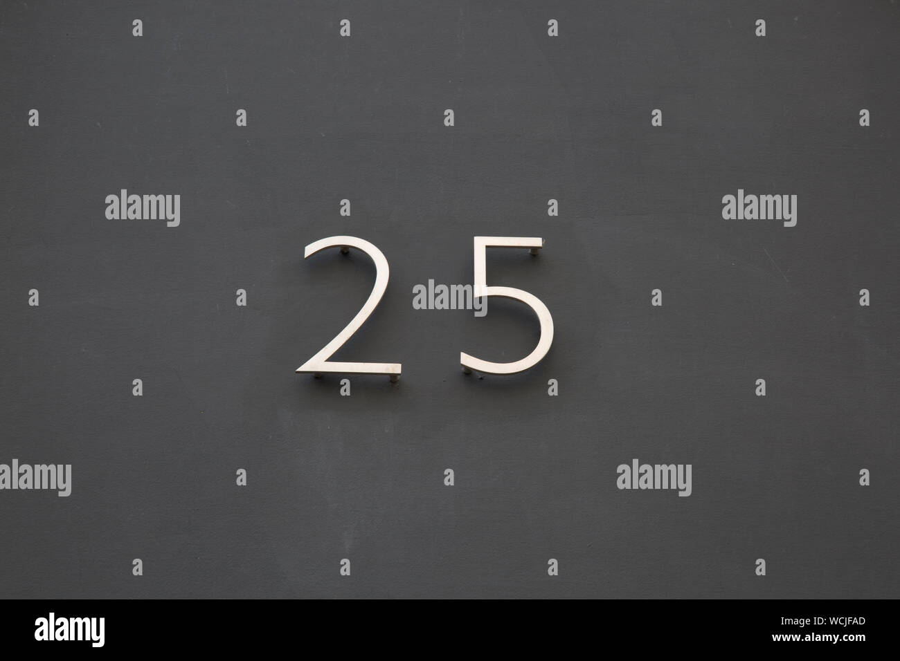 Number Twenty-Five on Black Wall Stock Photo - Alamy