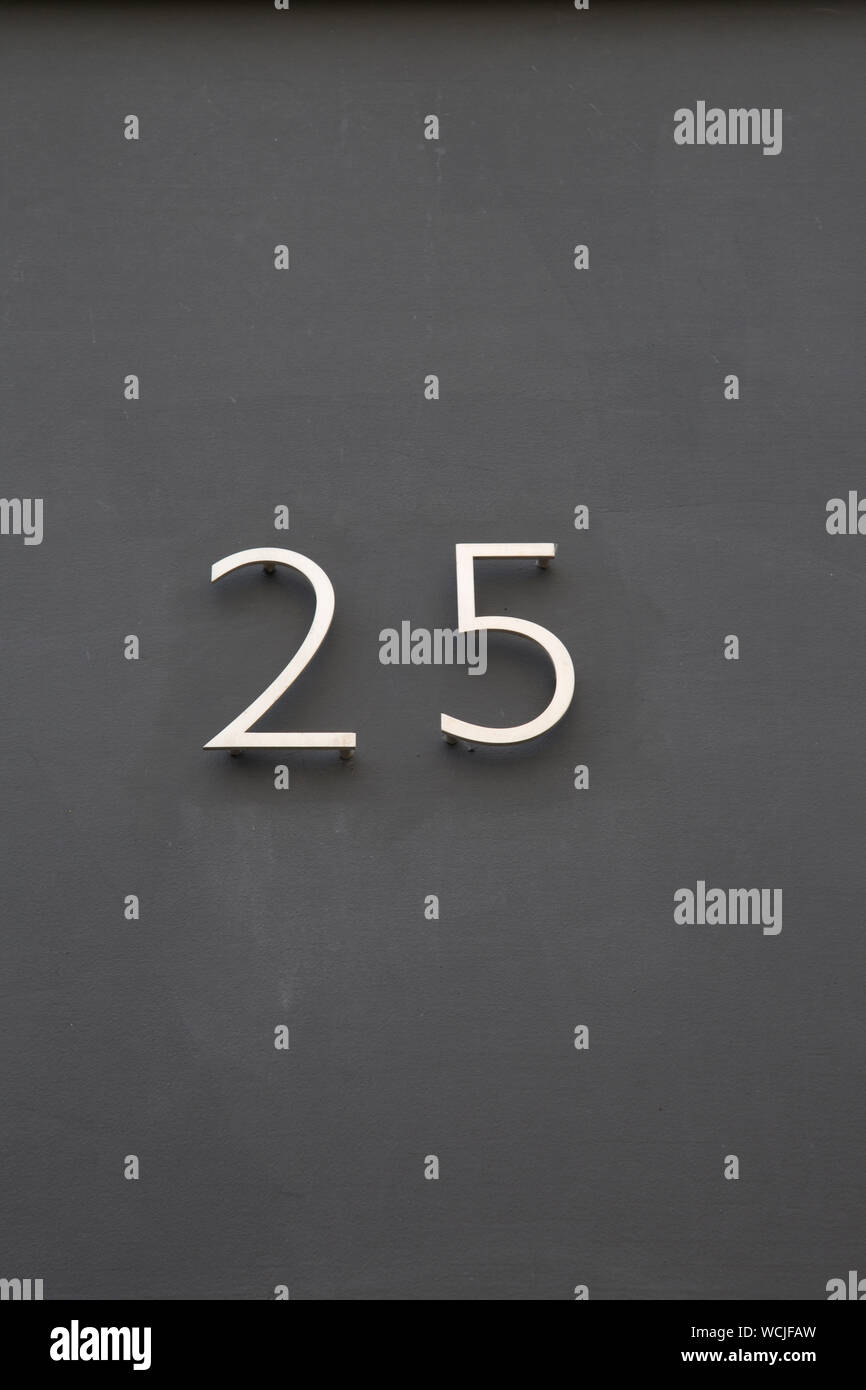 Closeup of Number Twenty-Five on Black Wall Stock Photo - Alamy