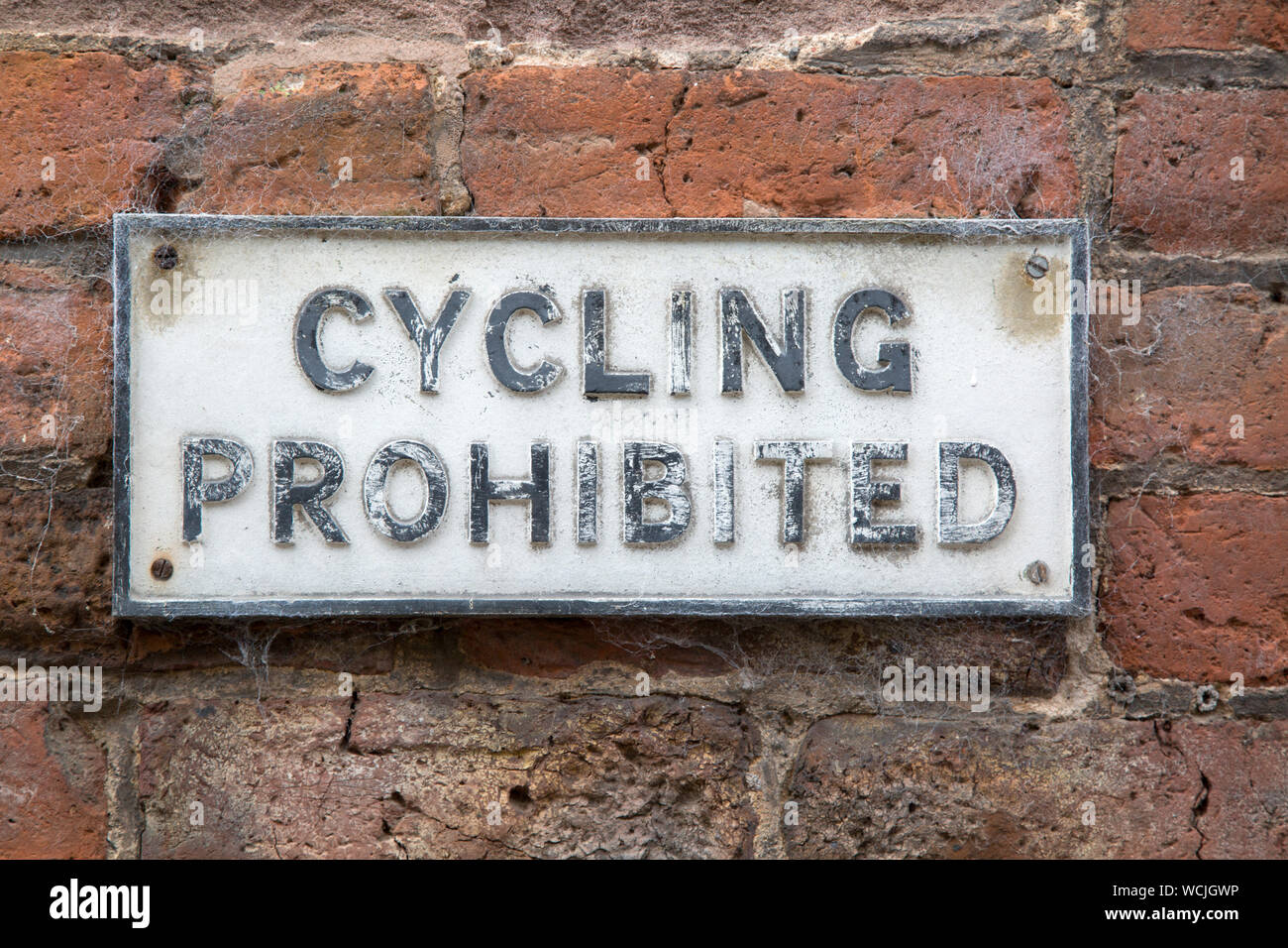 Old Cycling Prohibited Sign on Brick Wall Stock Photo - Alamy