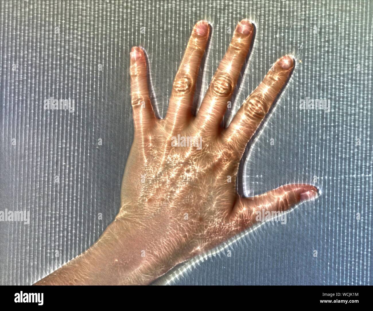 Foto of a glowing human female hand with a kirlian aura showing ...