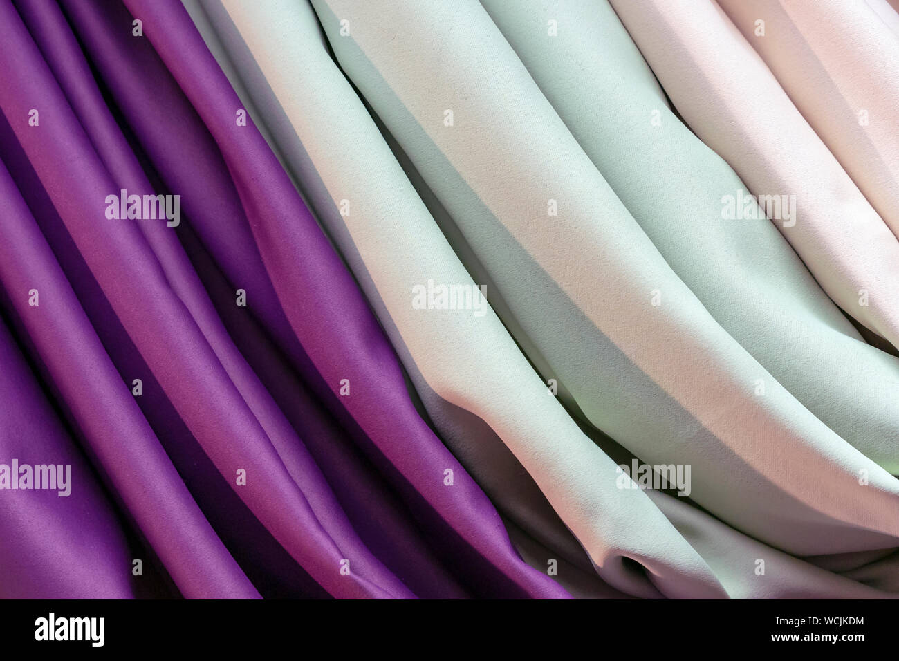 Satin fabric in the shop window. Texture of satin fabri Stock Photo - Alamy