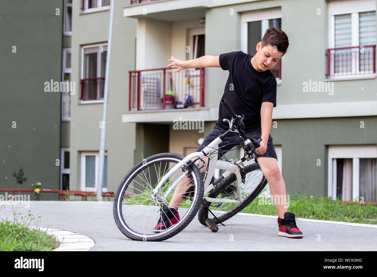 Young boy before a fall on a ground of his bike Stock Photo - Alamy