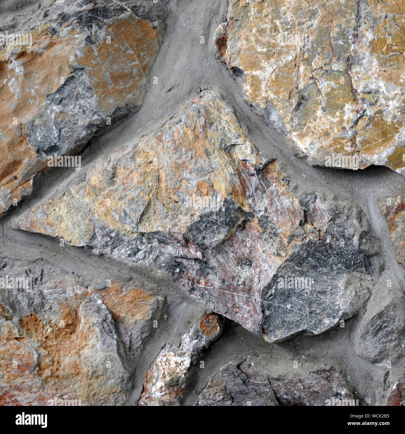 Wall made of natural stone with a red tint. Texture, background Stock ...