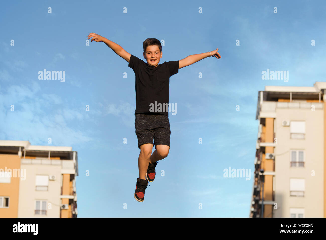 Cute emotional little boy jumping high, i can fly, Kid jumping from ...