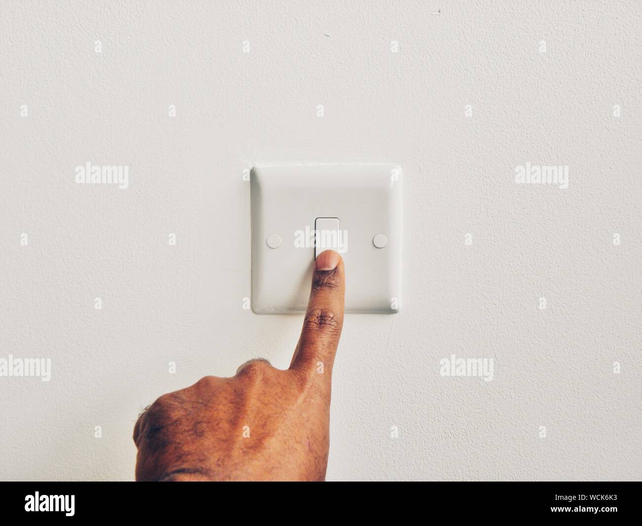 Light button wall hand hi-res stock photography and images - Alamy