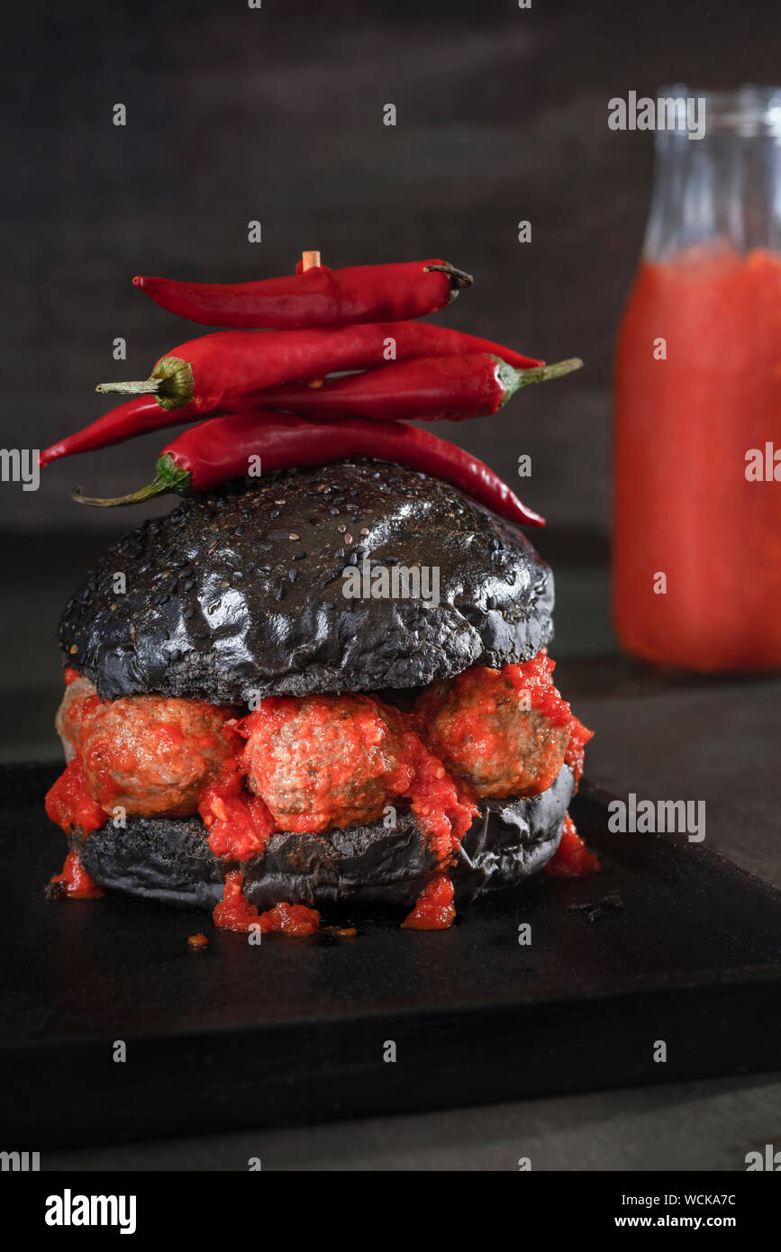 Spicy hamburger with black bread buns and Swedish meatballs and tomato ...