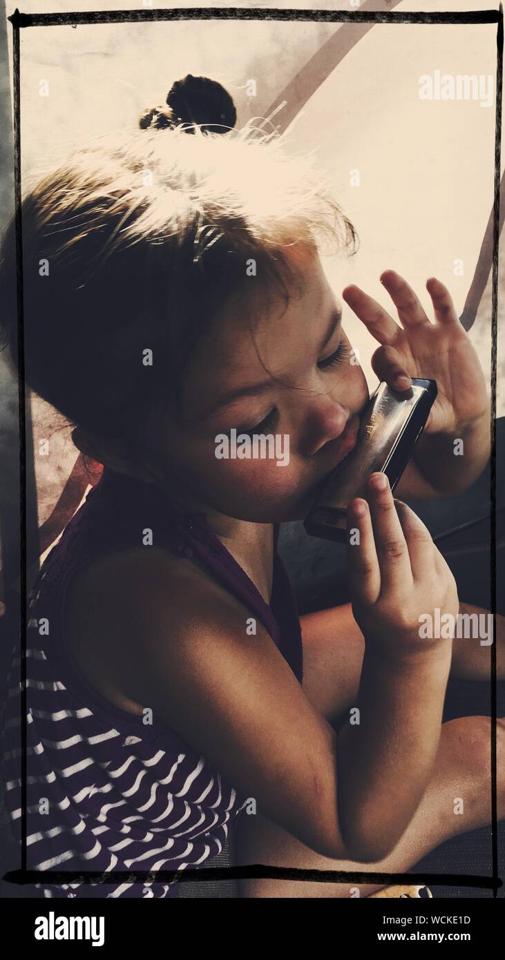 Boy playing harmonica hi-res stock photography and images - Alamy