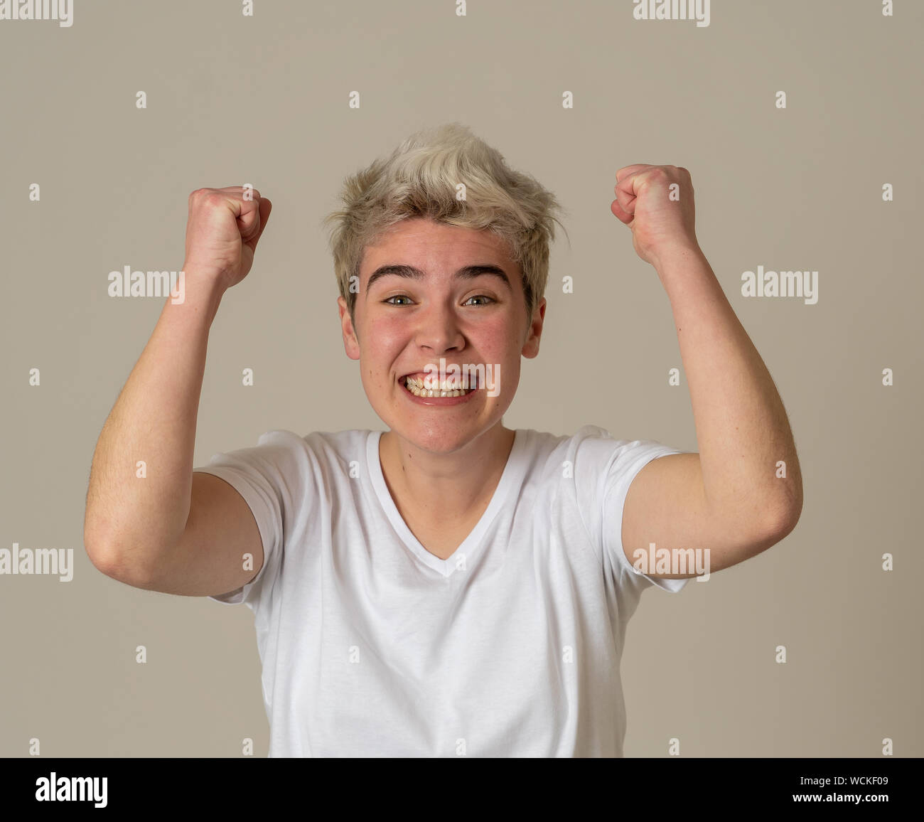 Portrait of young happy and excited transgender teen happy and excited ...