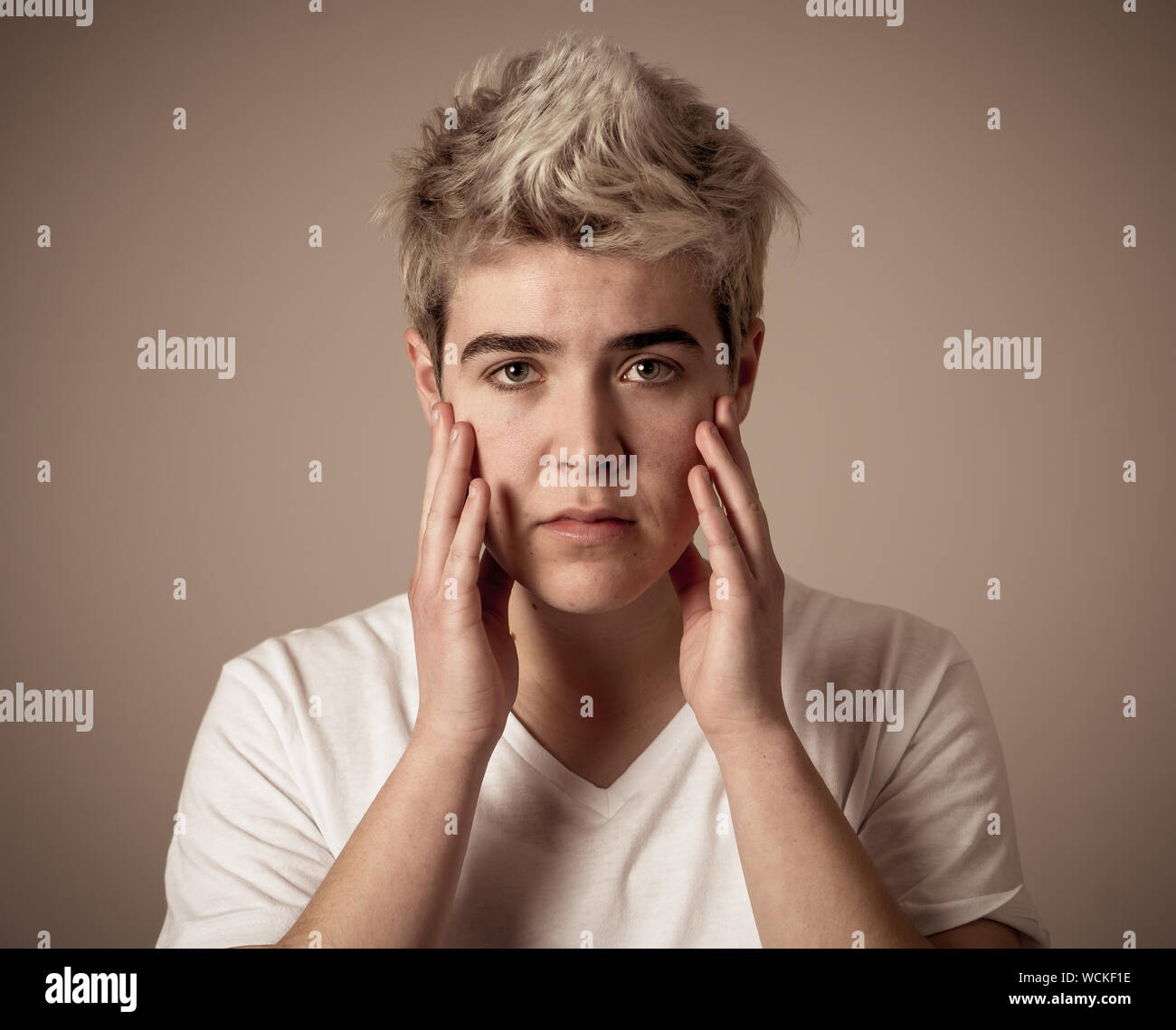 Young sad trans teenager boy suffering from depression feeling sad and ...