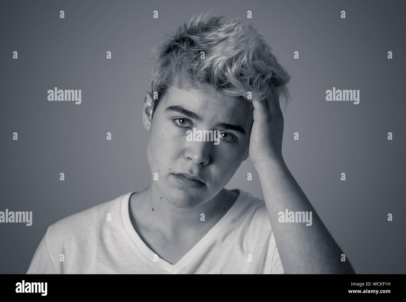 Young sad trans teenager boy suffering from depression feeling sad and ...