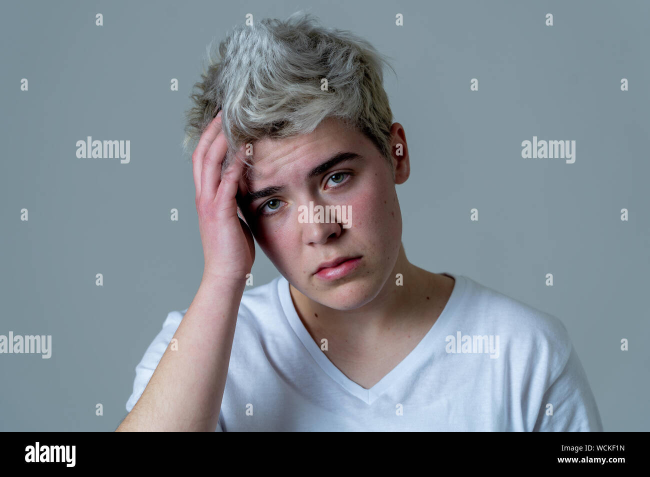 Young sad trans teenager boy suffering from depression feeling sad and ...