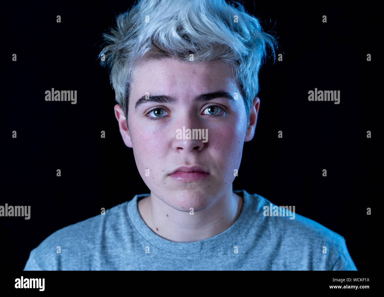 Close up portrait of young transgender teenager male with natural and ...