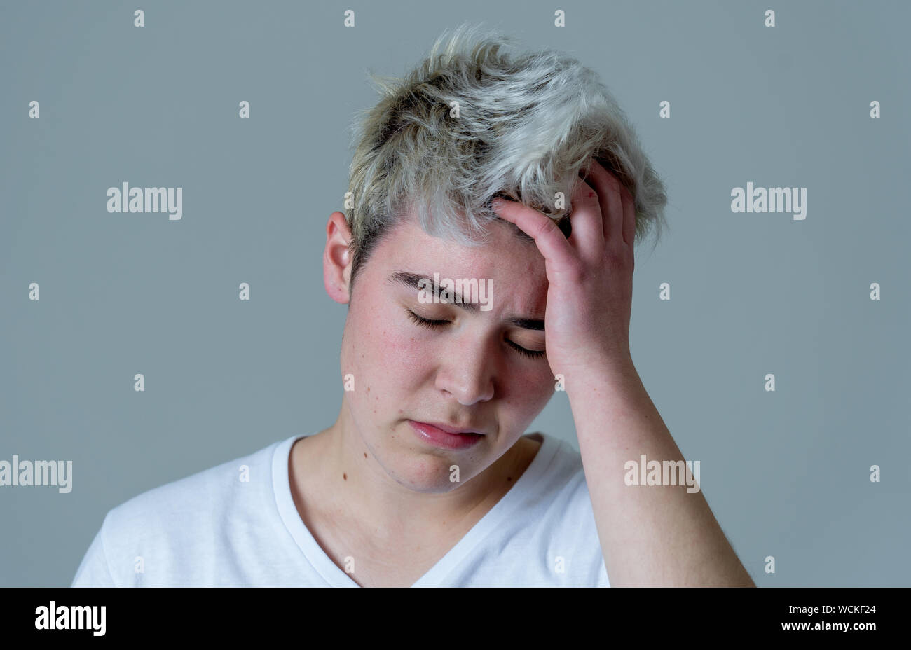 Young sad trans teenager boy suffering from depression feeling sad and ...