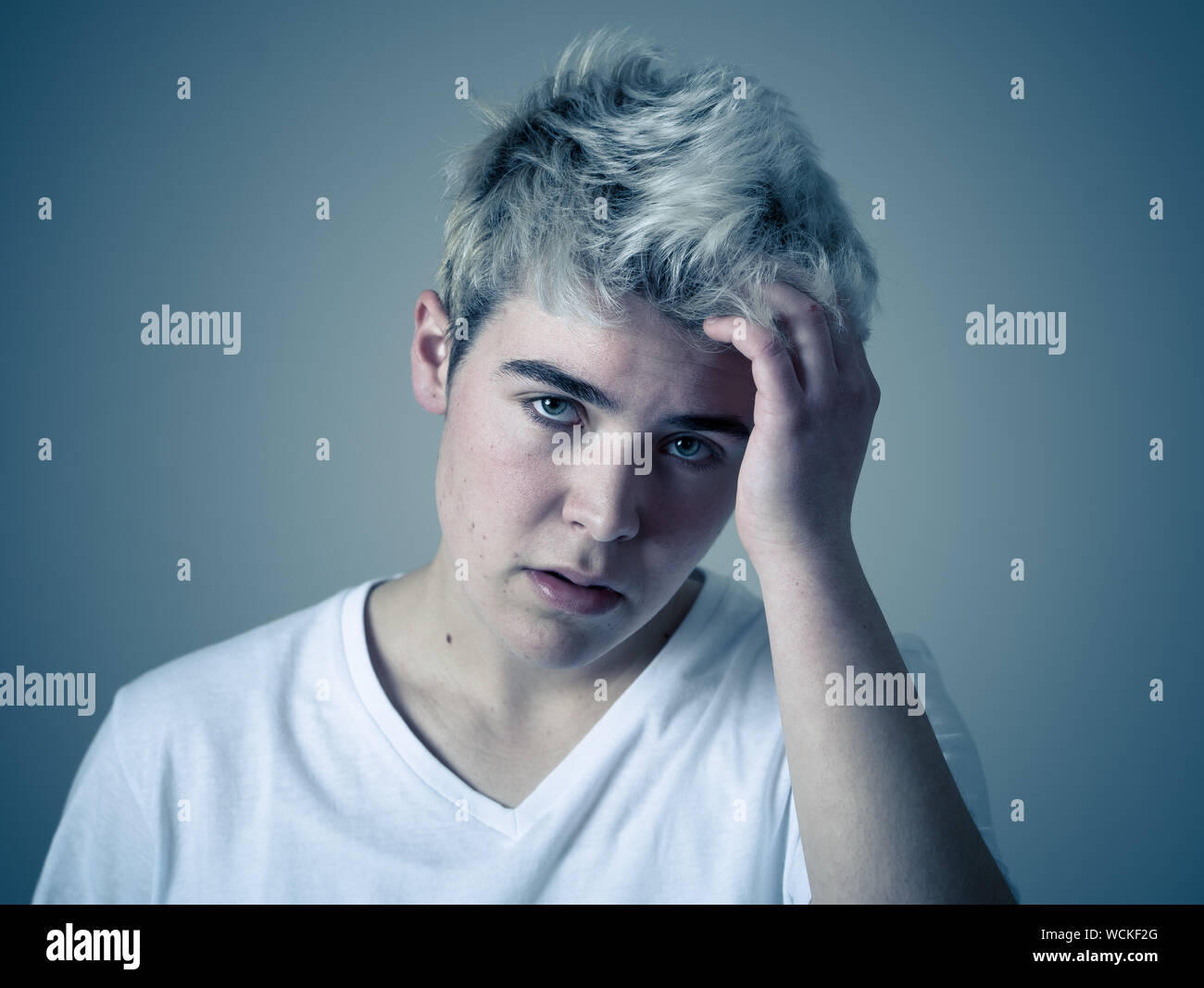 Young sad trans teenager boy suffering from depression feeling sad and ...