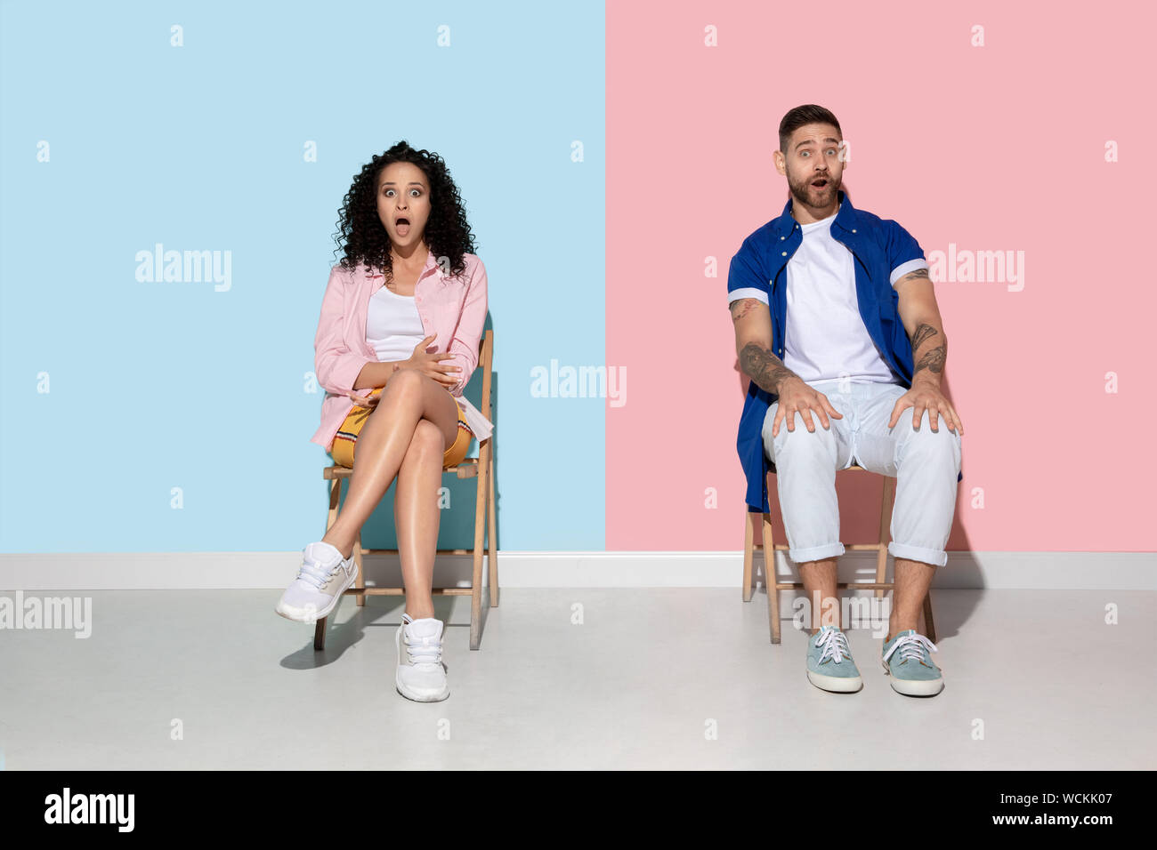 Young emotional caucasian couple in bright casual clothes posing on ...