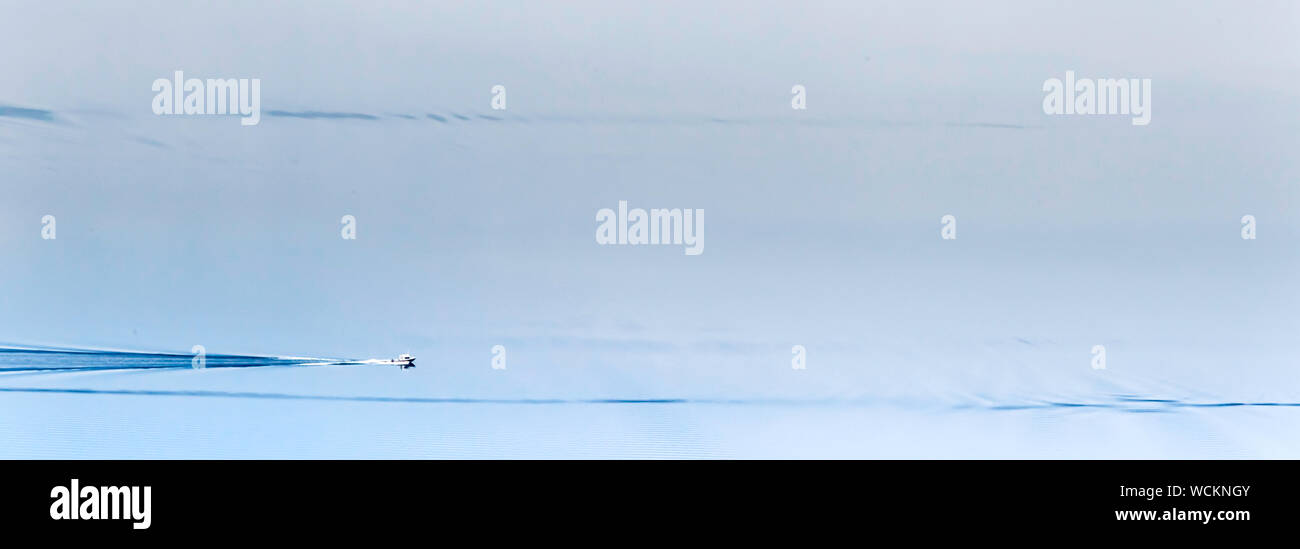 Aerial image from a helicopter as a lone boat leaves a wake on Atlin ...