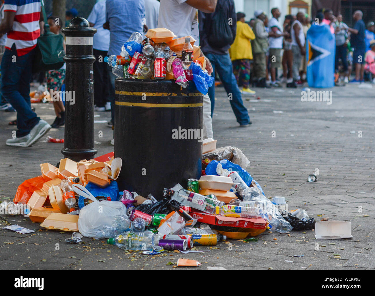 Overflow bin with rubbish after festival. Food package, empty plastic ...