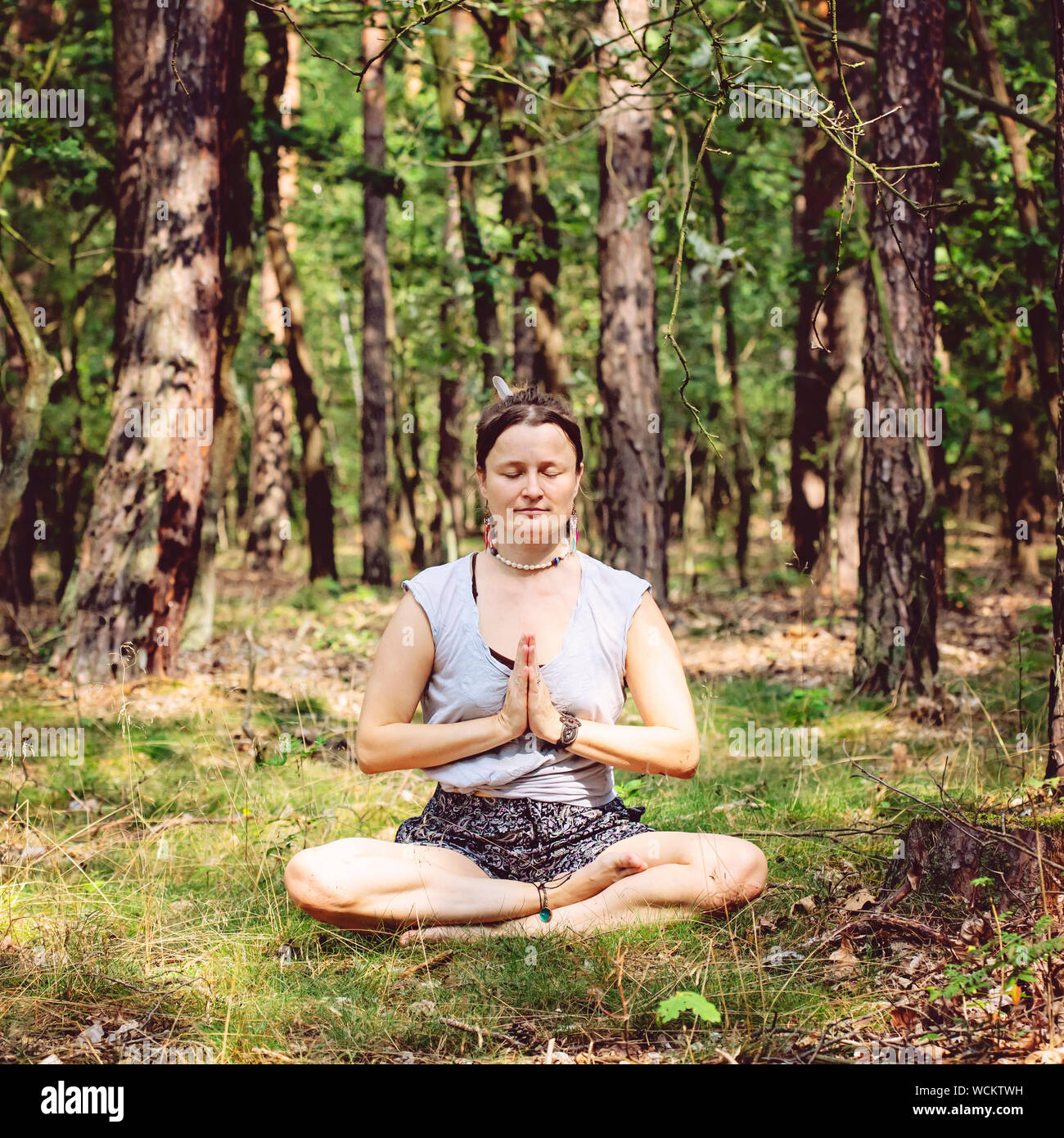 young woman meditating alone and silent in summer forest Stock Photo ...