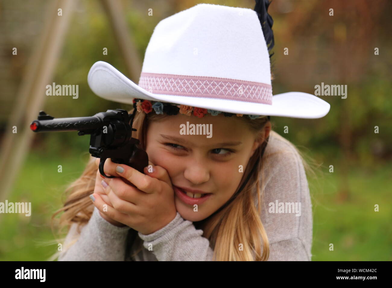 Girl playing toy gun hi-res stock photography and images - Alamy
