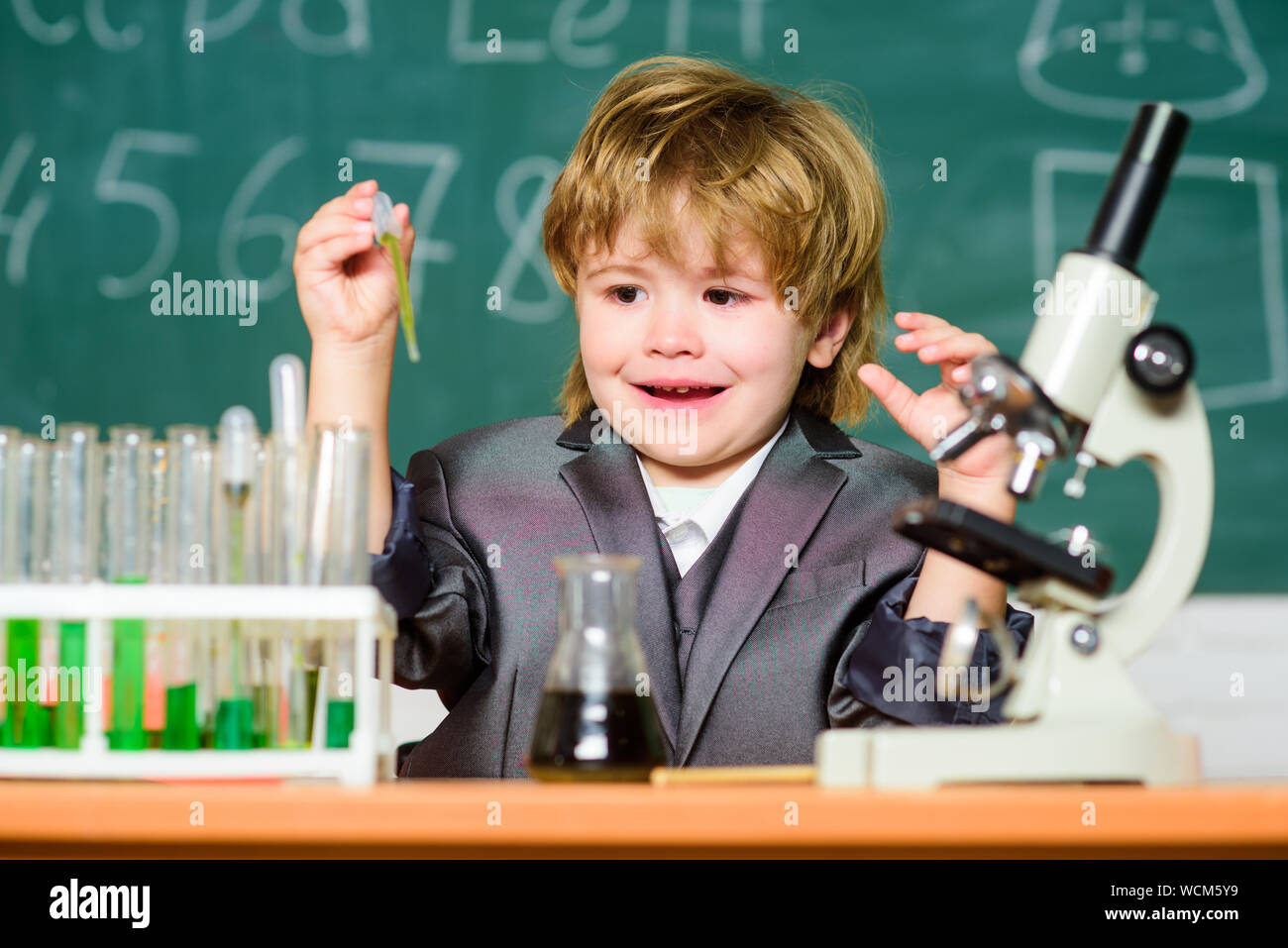 Explore biological molecules. Toddler genius baby. Boy near microscope ...