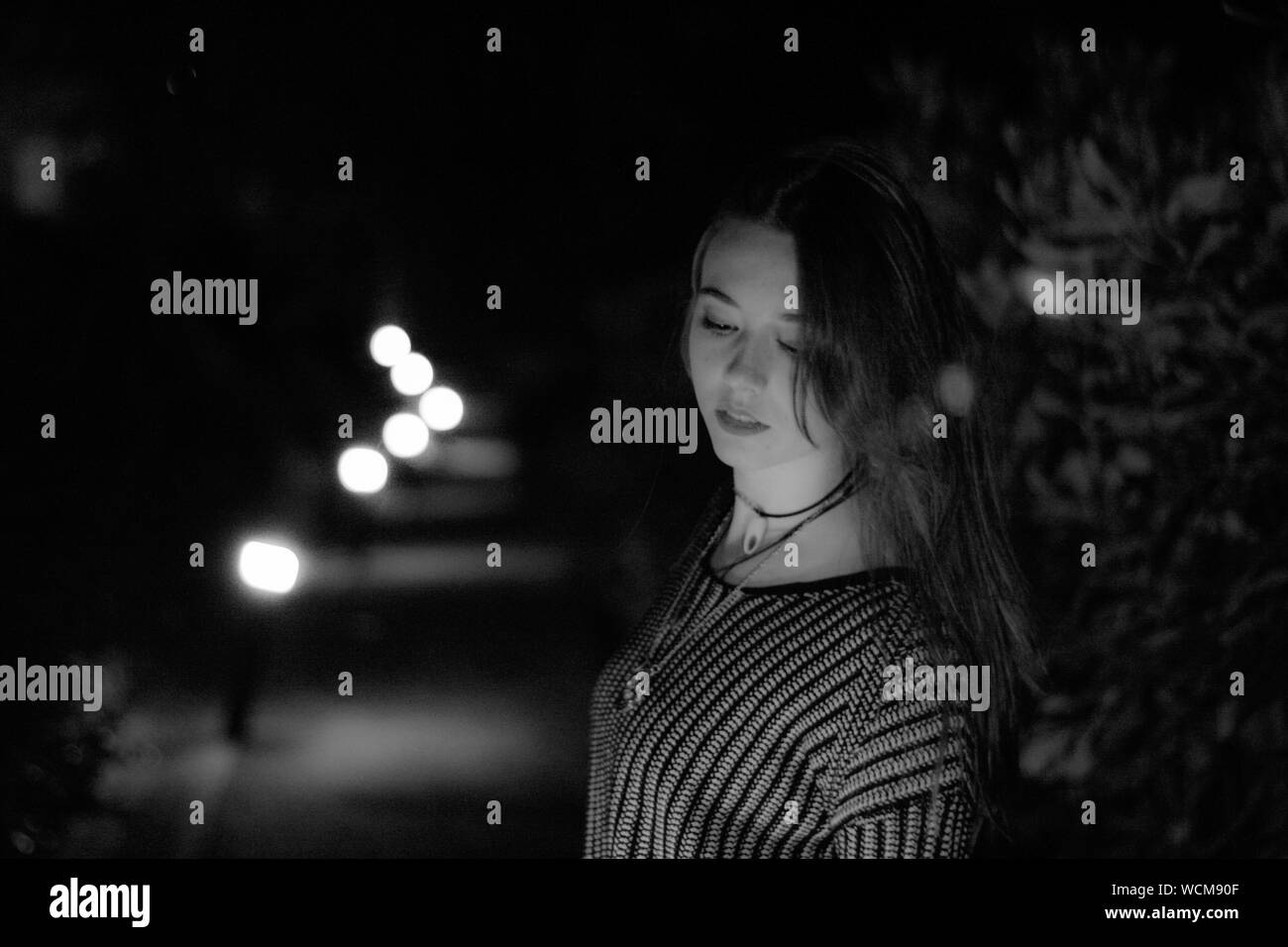 Woman looking down side view Black and White Stock Photos & Images - Alamy