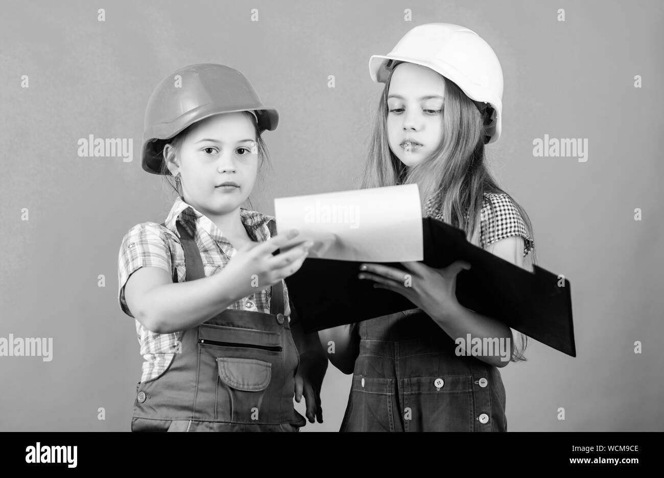 small girls repairing together in workshop. school project. Happy ...