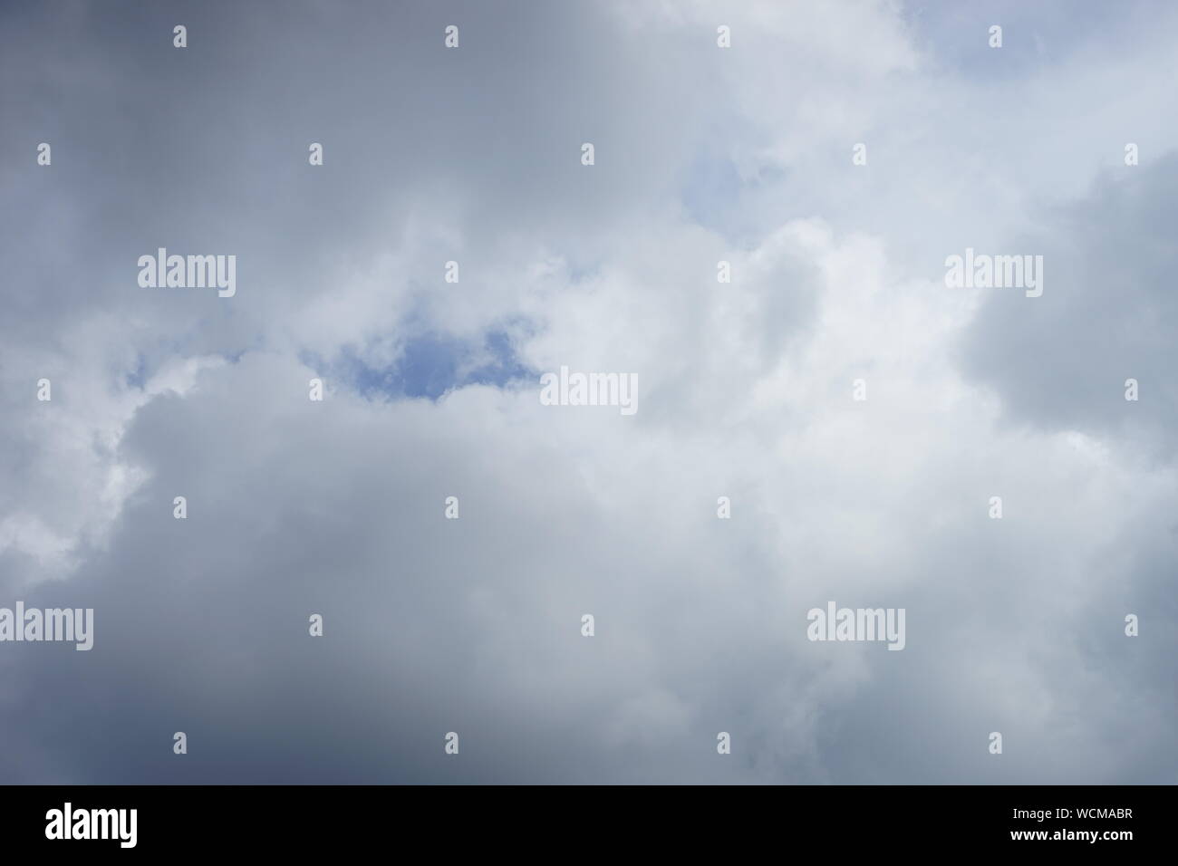 large-sized gray thunderclouds covered almost the entire blue sky Stock ...