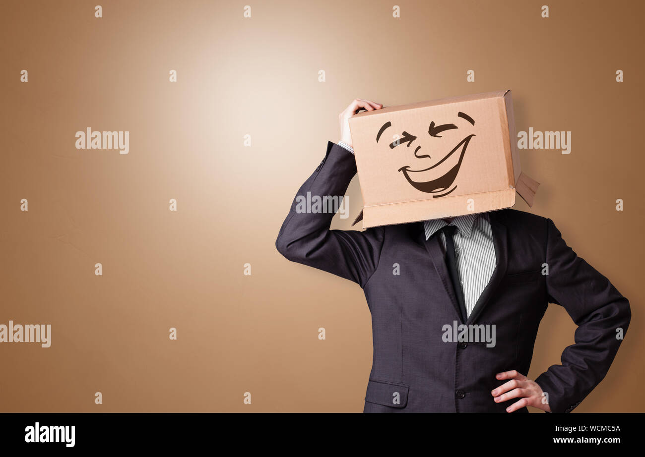 Young boy standing and gesturing with a cardboard box on his head Stock ...