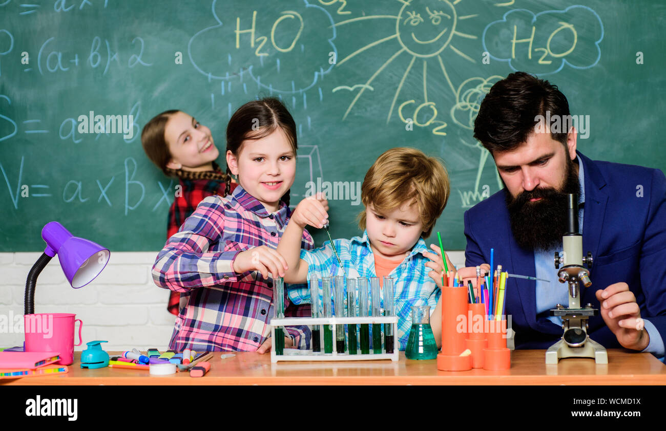 Little kids learning chemistry in school laboratory. school kids ...