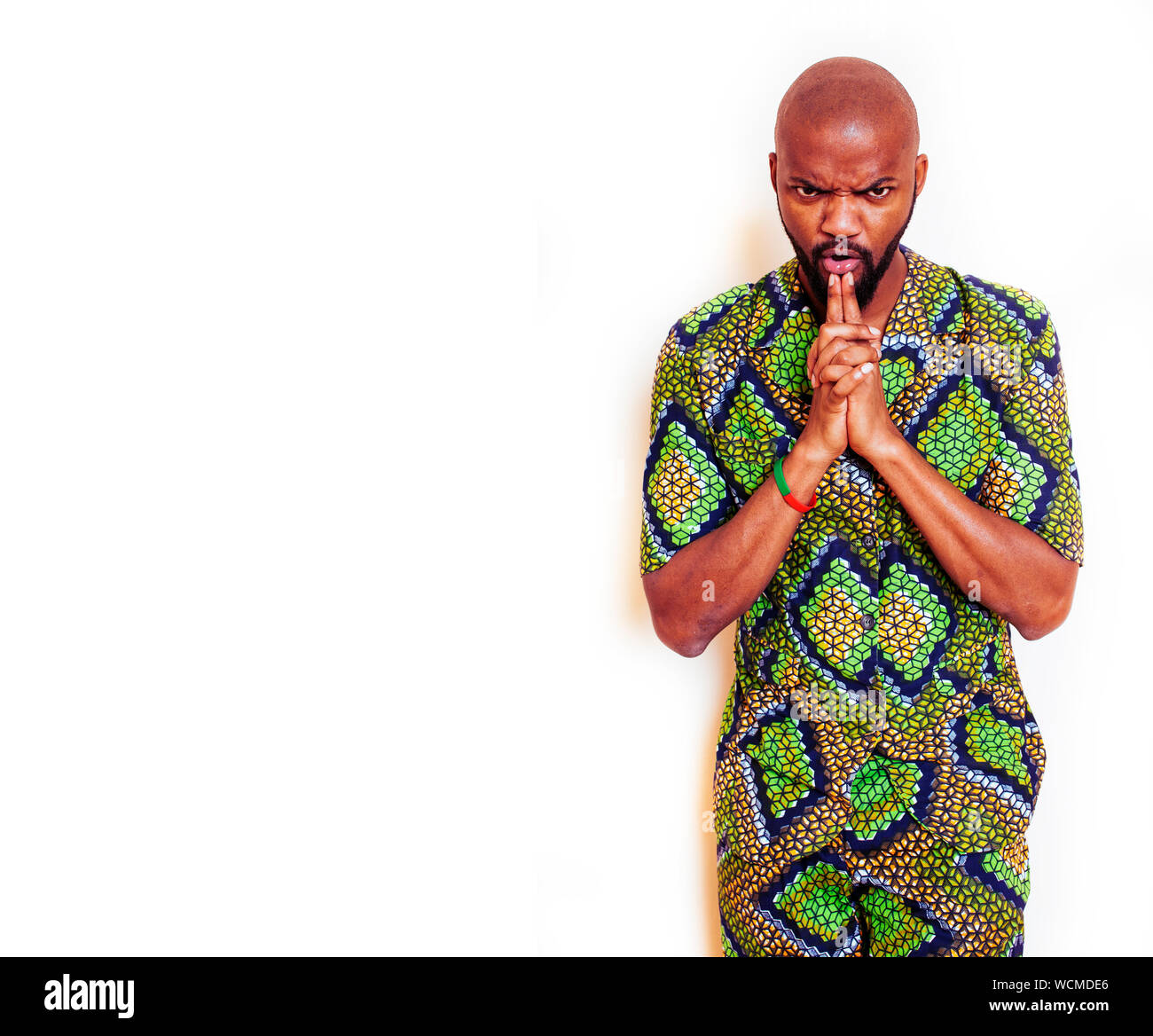 portrait of young handsome african man wearing bright green national ...