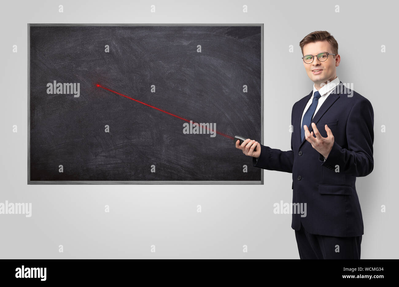 Handsome young teacher with laser pointer teaching Stock Photo - Alamy