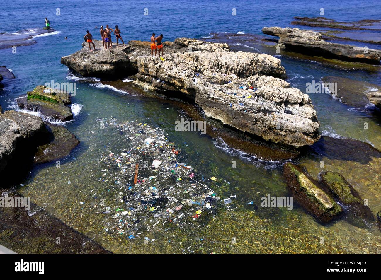Beirut, Lebanon. 28th Aug, 2019. People swim near floating garbage in ...