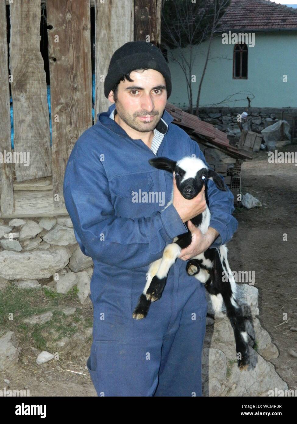 Young man holding lamb hi-res stock photography and images - Alamy