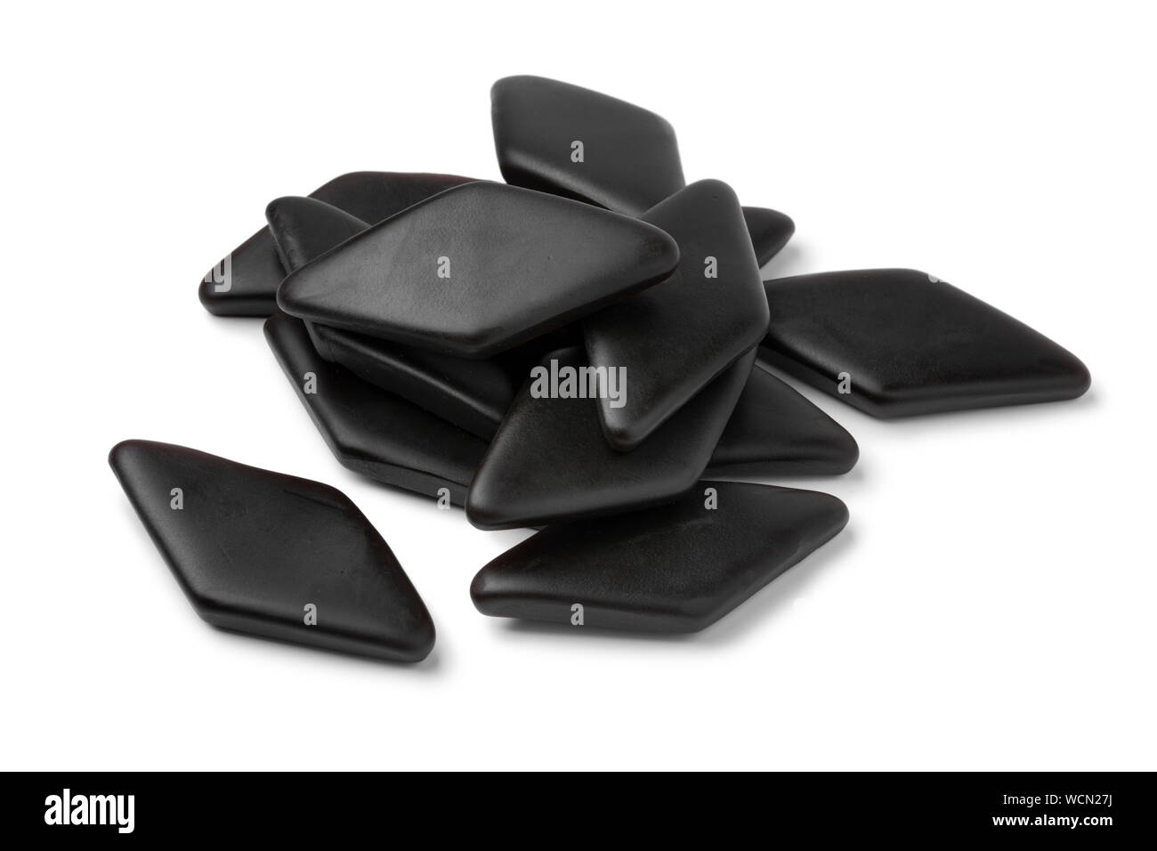 Heap of black salt licorice confection, a Dutch candy, isolated on ...