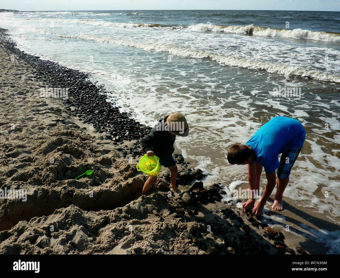 Two boys playing in the sand hi-res stock photography and images - Alamy