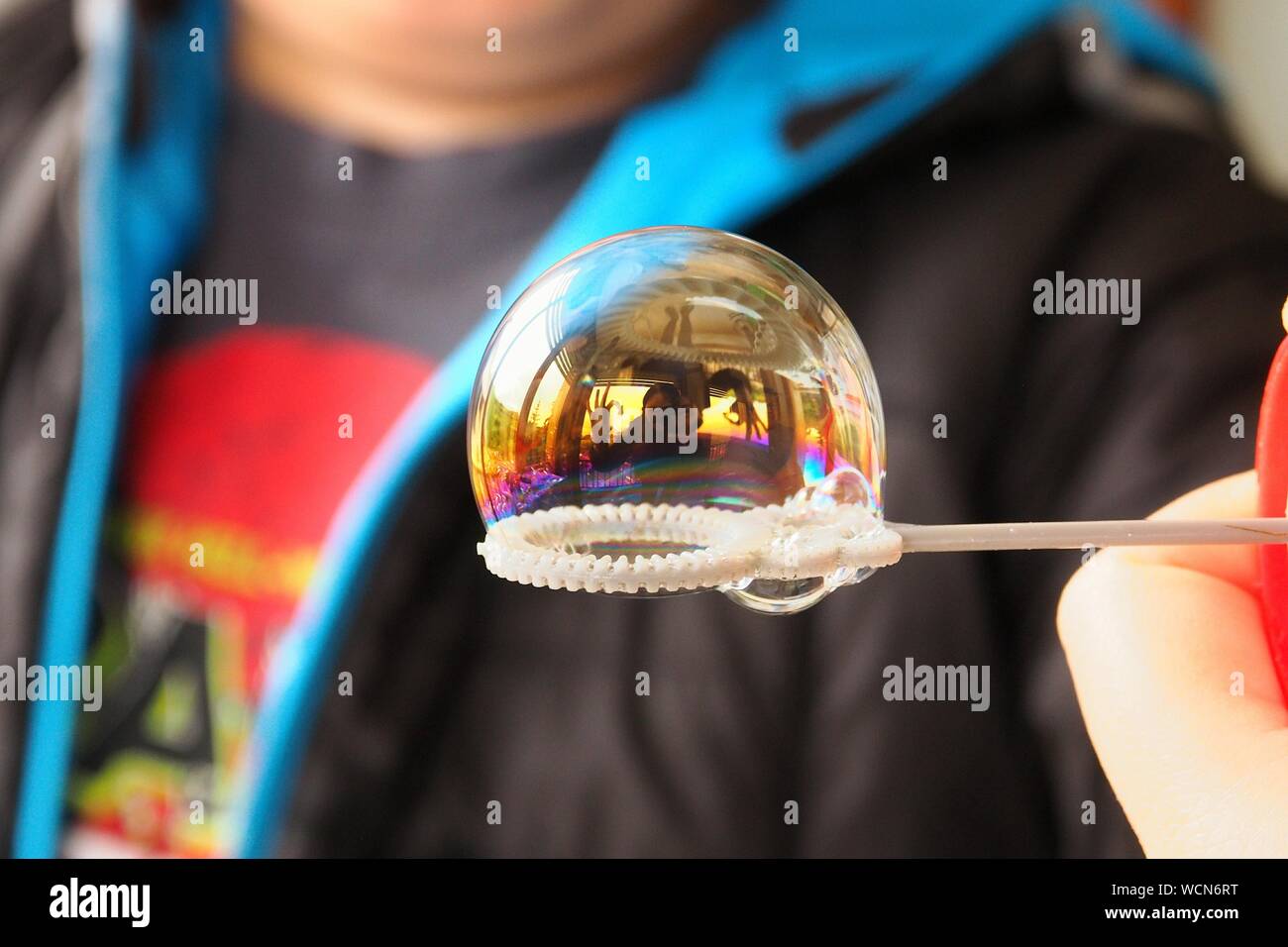 Hand holding bubble wand hi-res stock photography and images - Alamy