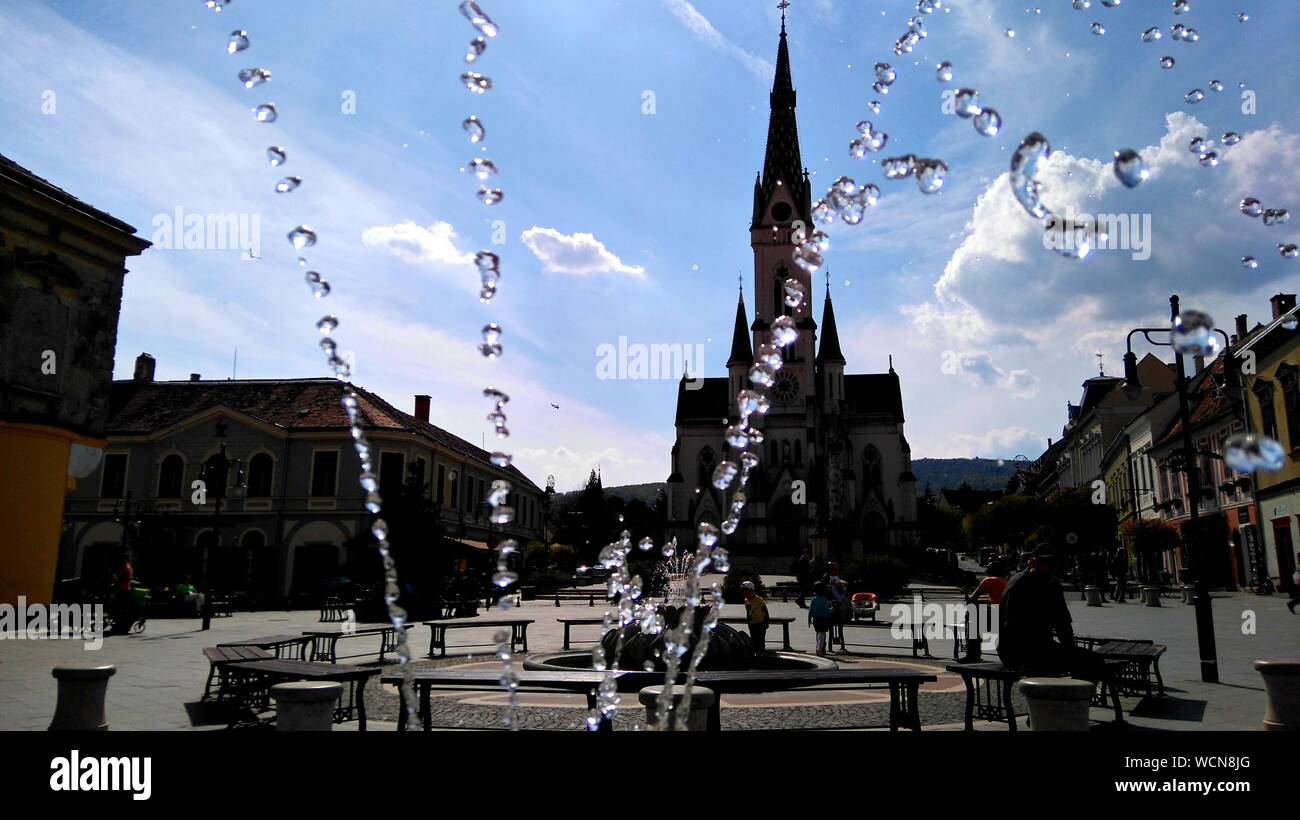 Water Spray With Fountain And Church In Background Stock Photo - Alamy