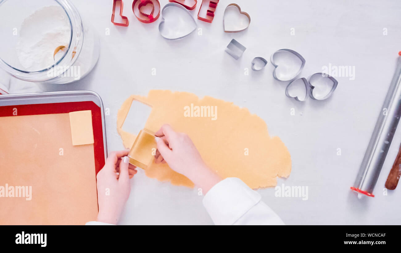 Flat lay. Step by step. Cutting out shapes from sugar cookie dough with ...