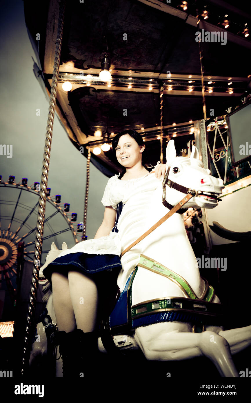 Woman sitting horse on carousel hi-res stock photography and images - Alamy
